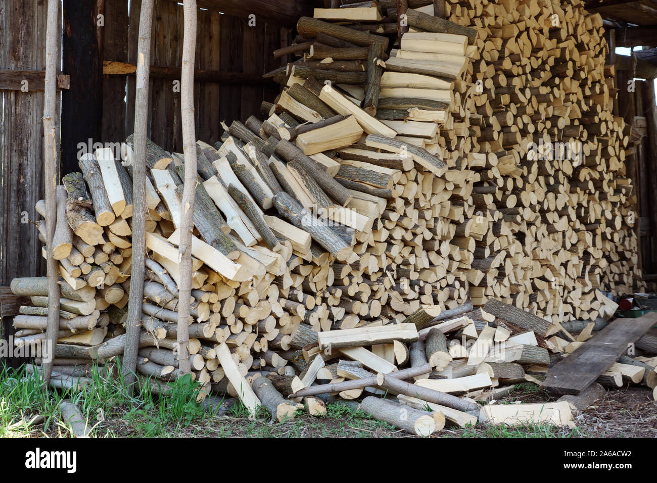 Fallen firewood stack in shed close up Stock Photo - Alamy