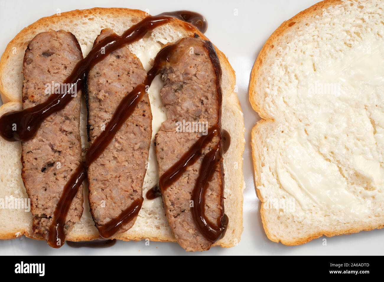 Sausage sandwich with brown sauce Stock Photo - Alamy