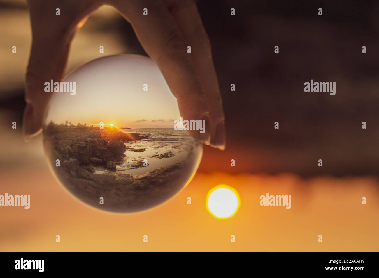 Wild, nature. Sunset beach View through a glass, crystal ball (lensball ...