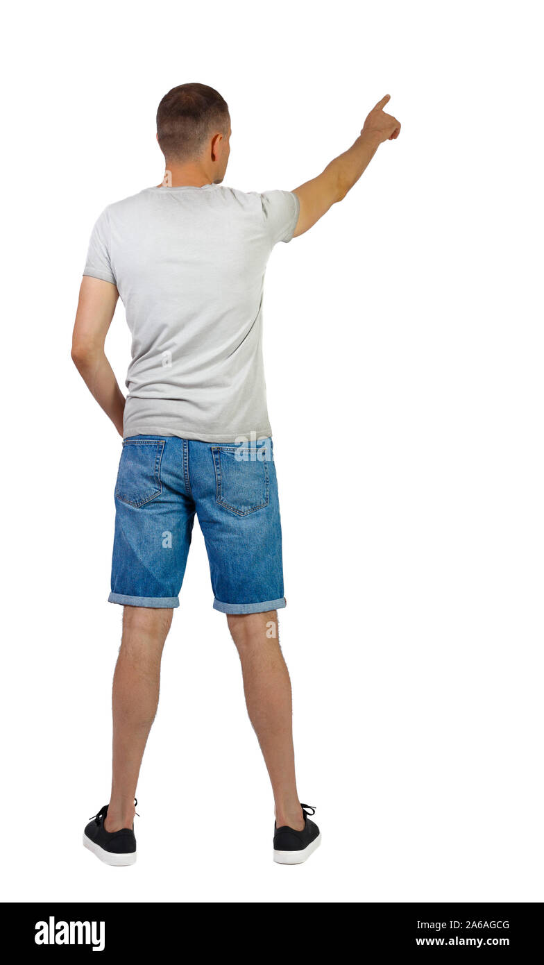 Back view of going handsome man in shorts pointing. walking young guy ...
