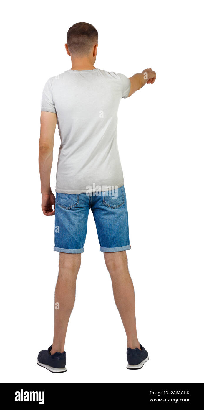 Back view of going handsome man in shorts pointing. walking young guy ...