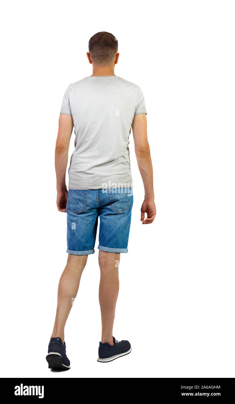 Back view of going handsome man in shorts. walking young guy .backside ...