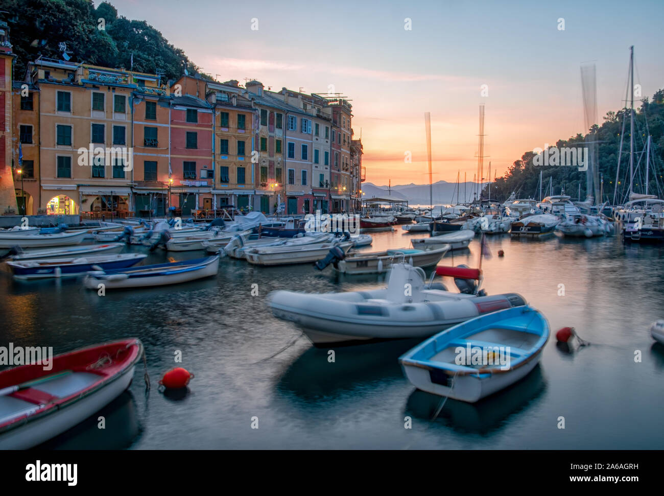 Boats in the sheltered harbor at Portofino, Liguria Italy at sunset ...