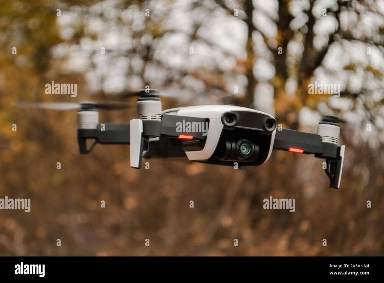 quadrocopter hanging in the air on a blurry background above the ground ...