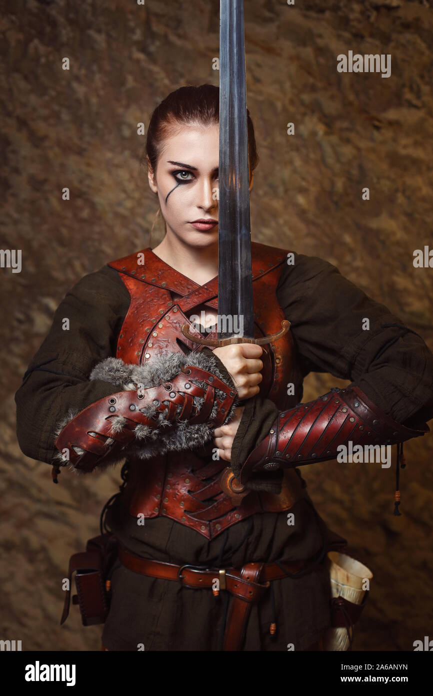 Warrior woman posing with sword Stock Photo - Alamy