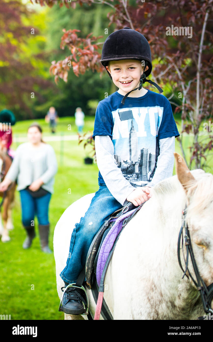A little boy with Autism, ADHD, Aspergers Syndrome, riding a horse with ...