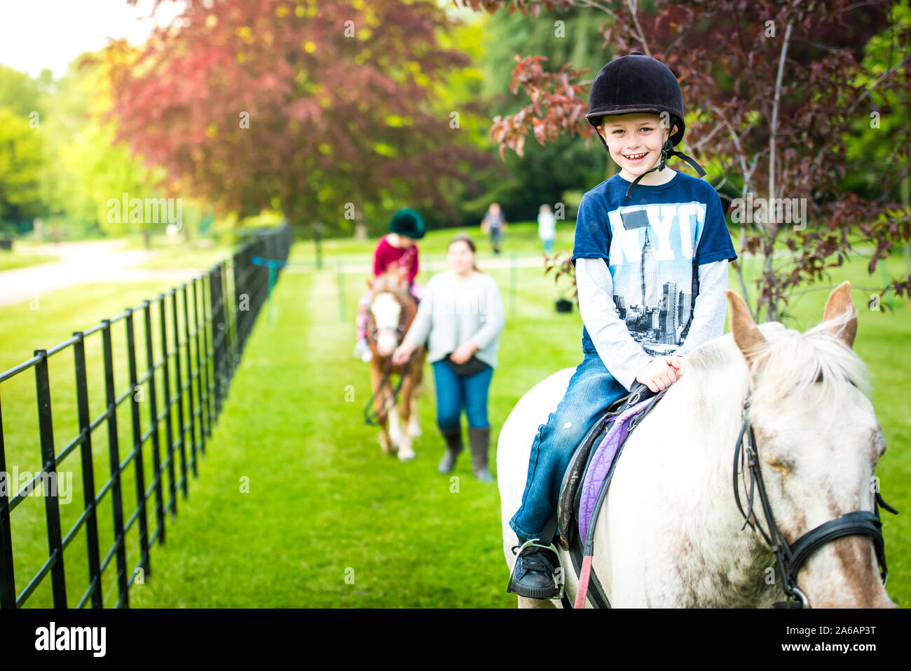 A little boy with Autism, ADHD, Aspergers Syndrome, riding a horse with ...