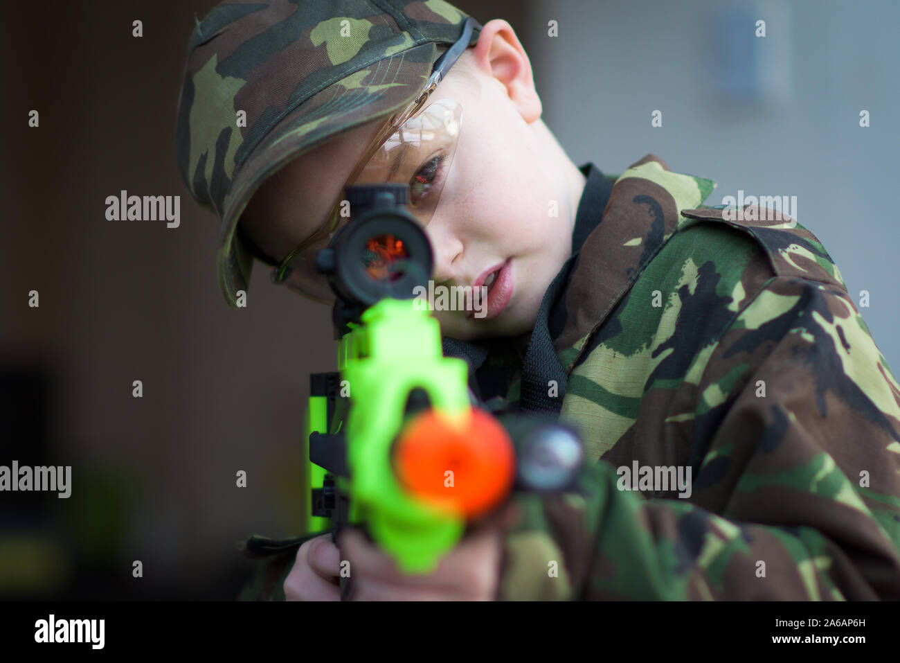 A little boy with ADHD, Autism poses in camouflage (DPMs) with his BB ...