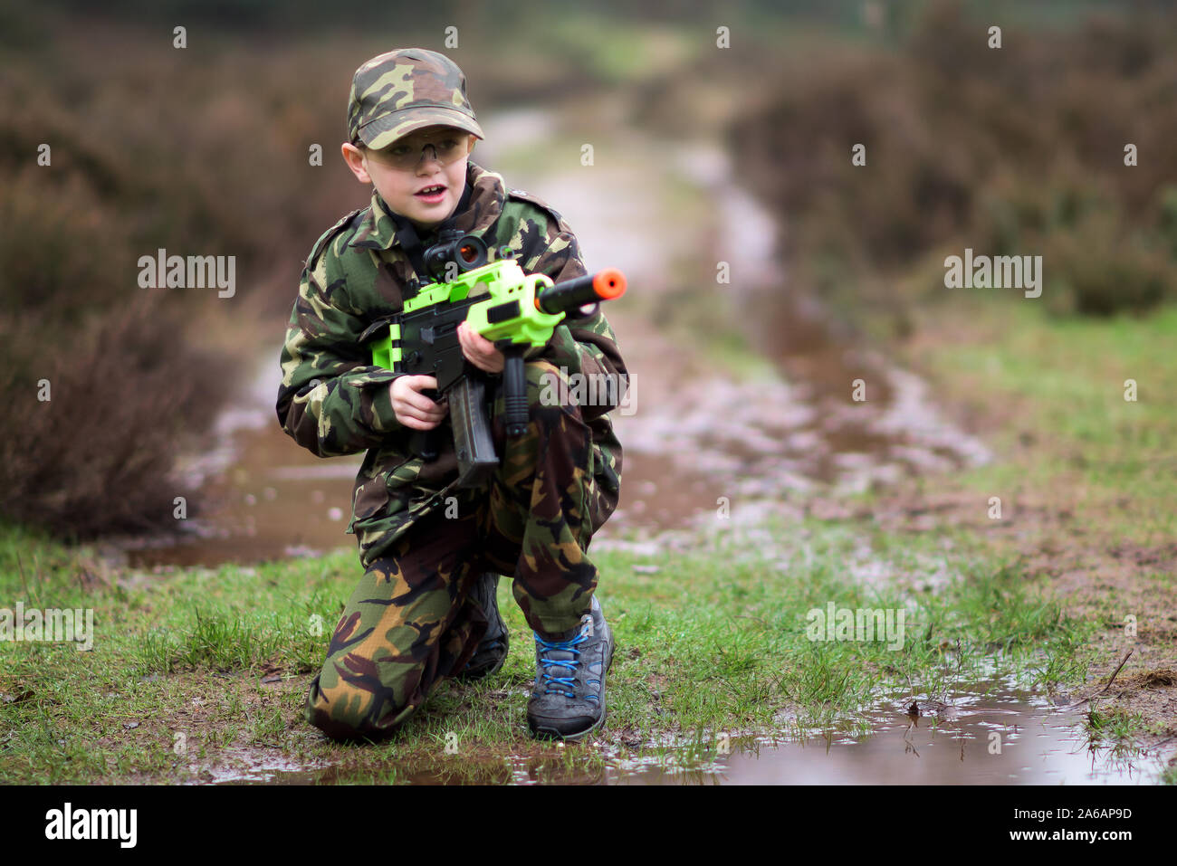 A little boy with ADHD, Autism poses in camouflage (DPMs) with his BB ...