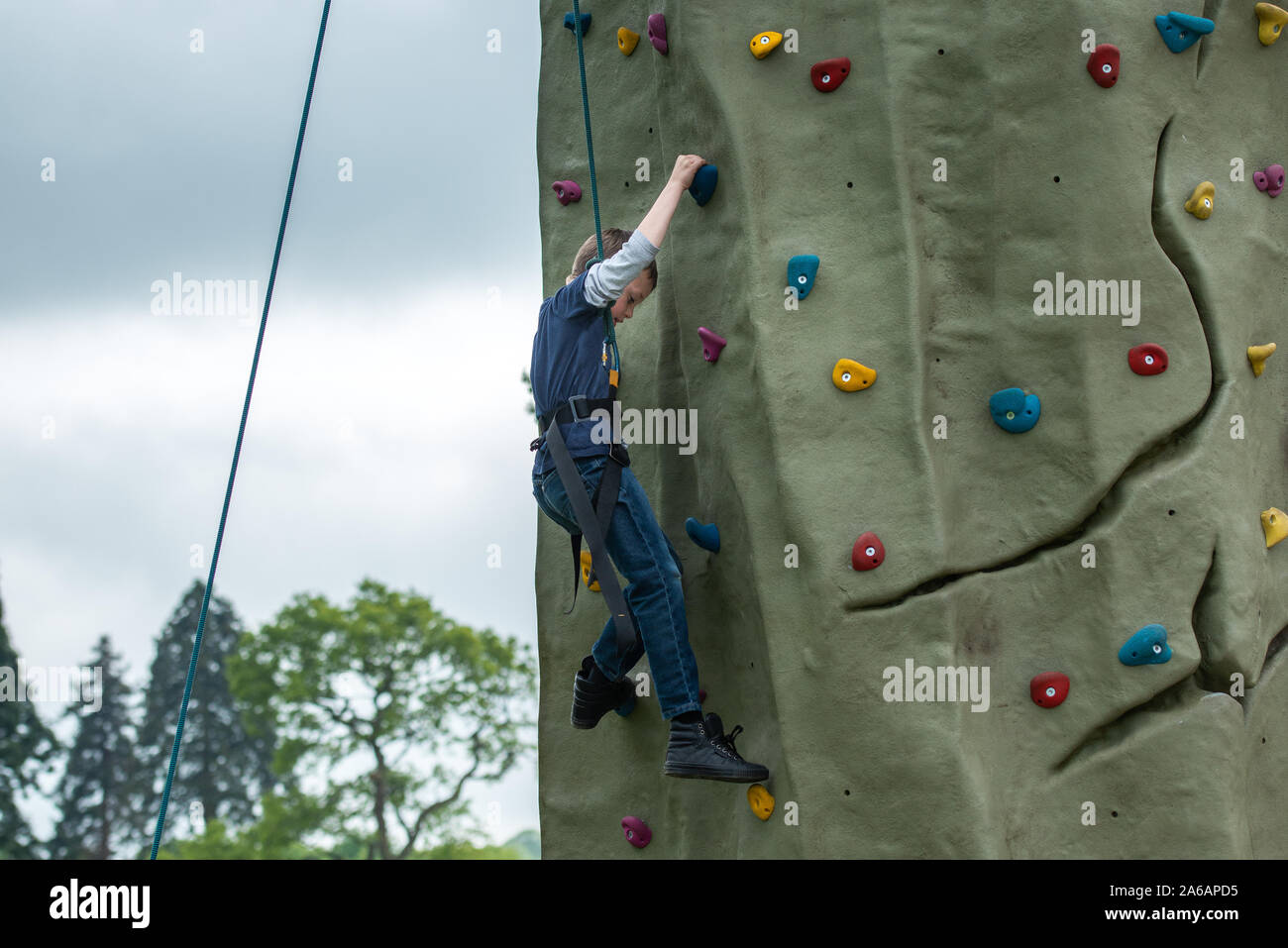 People try their hands at climbing on a huge mobile outdoor climbing ...