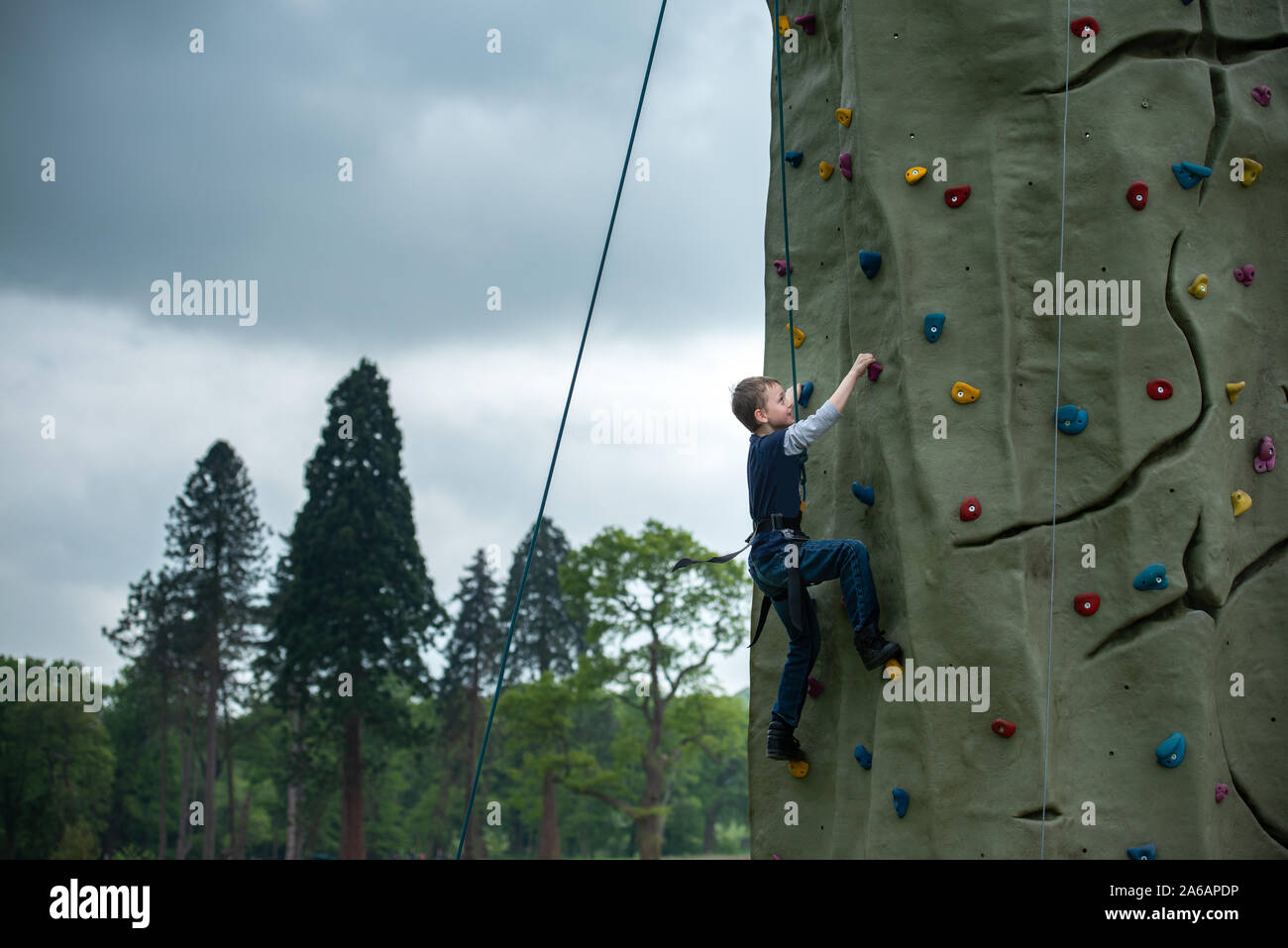 People try their hands at climbing on a huge mobile outdoor climbing ...