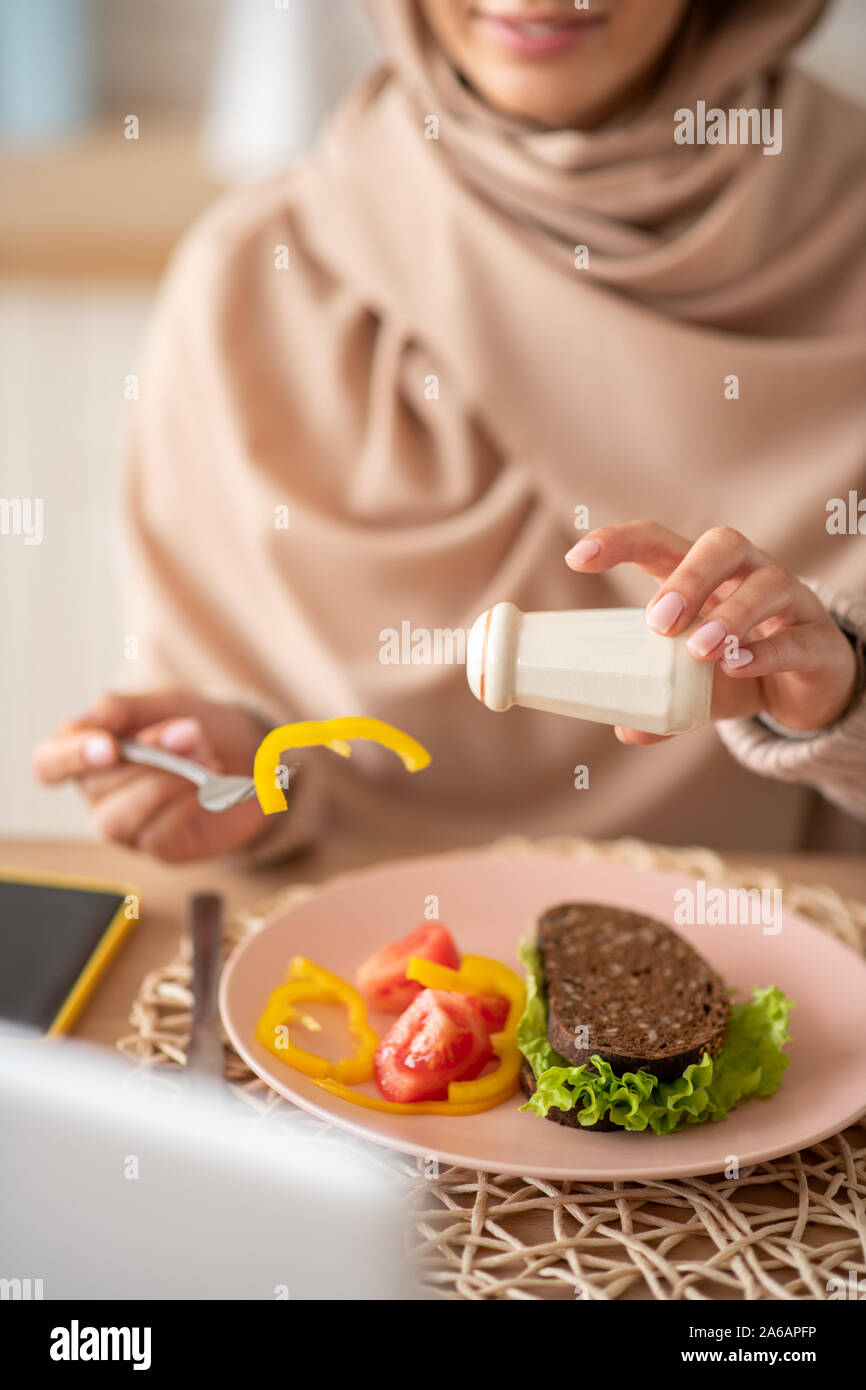 Woman adding salt to food hi-res stock photography and images - Alamy