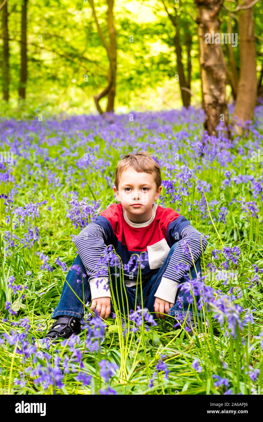 A handsome little boy with ADHD, Autism, Aspergers Syndrome sits and ...