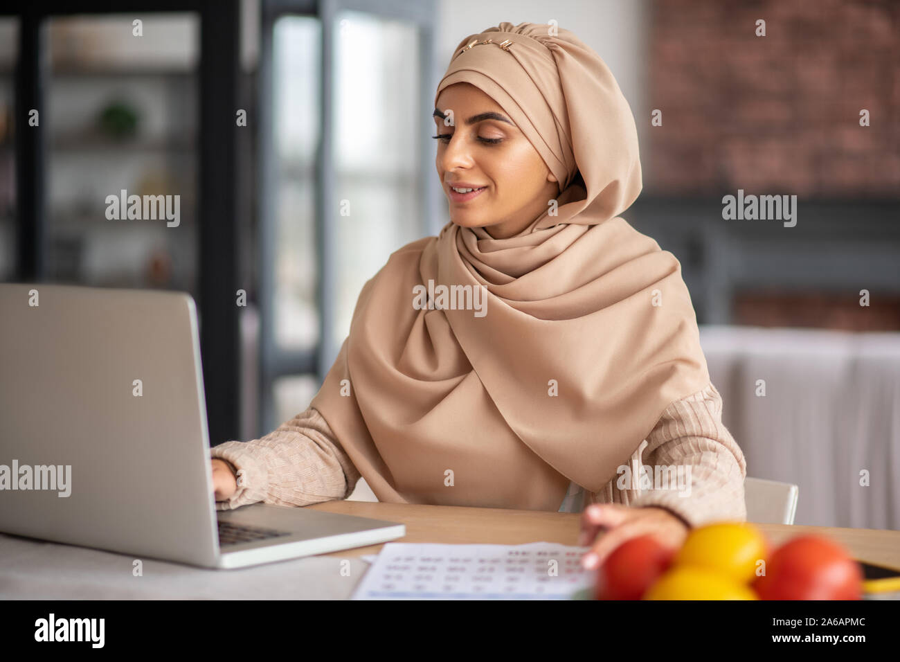 Pretty woman doing freelance work Stock Photo - Alamy