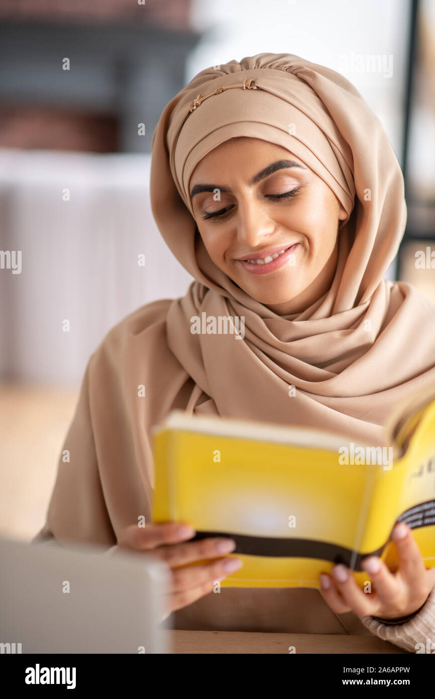 Young girl feeling interested and inspired by reading Stock Photo - Alamy