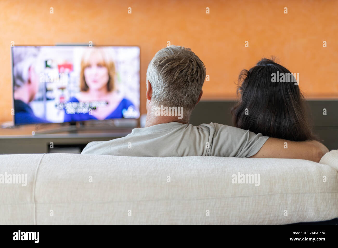 Middle-aged couple have a looking a TV at home Stock Photo - Alamy