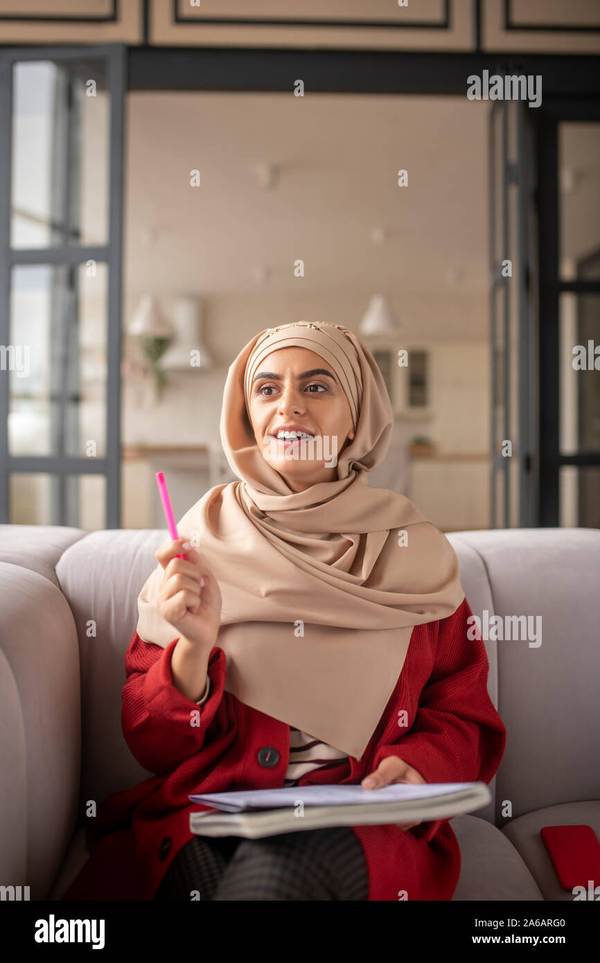 Pretty Muslim girl thinking about ideas for her essay Stock Photo - Alamy