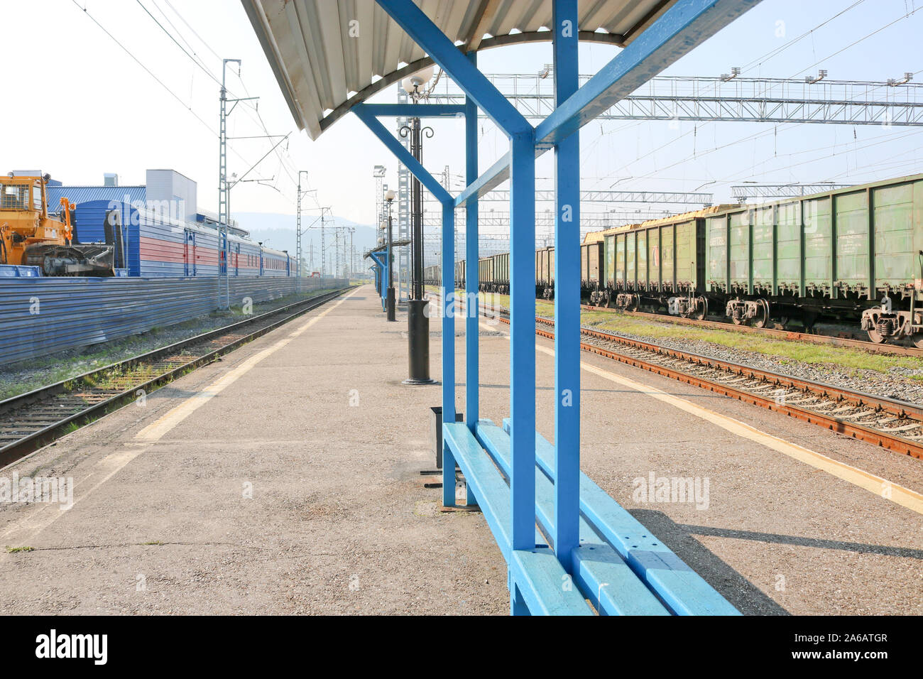 Freight train on the platform. Rail Cargo transit Stock Photo - Alamy