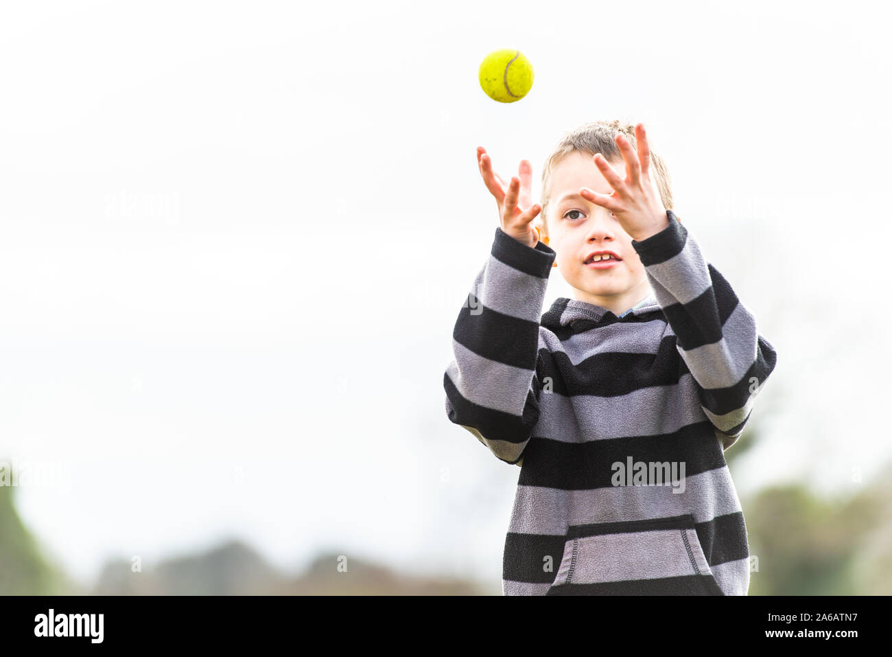 A handsome little boy with ADHD, Autism, Aspergers Syndrome practices ...