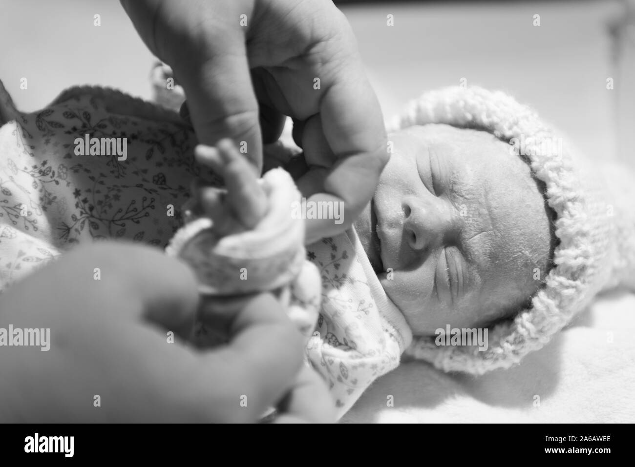 A young baby girl is born premature weighing just 4lbs, pictured here ...