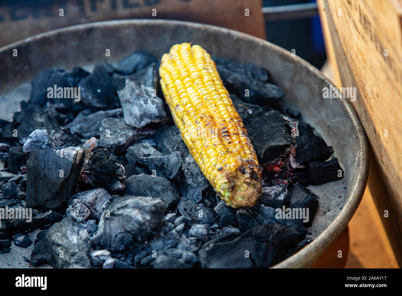 Yellow corn roasted on fire from black carbons Stock Photo - Alamy