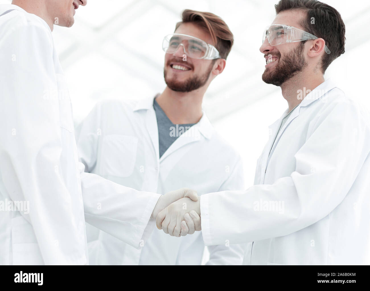 blurred image of a handshake between scientists Stock Photo - Alamy