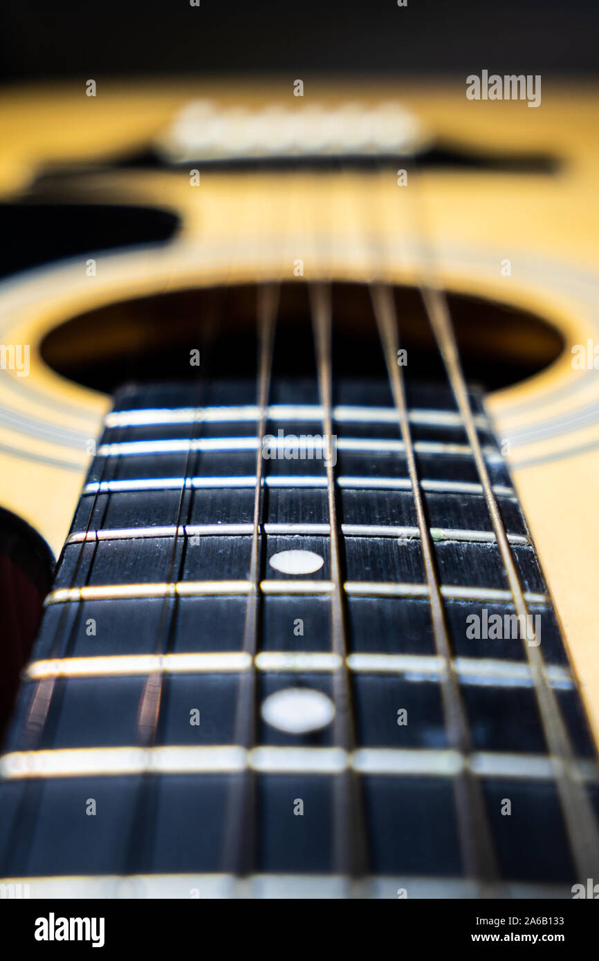 Isolated acoustic guitar, steel and nylon strings on a standard wooden ...