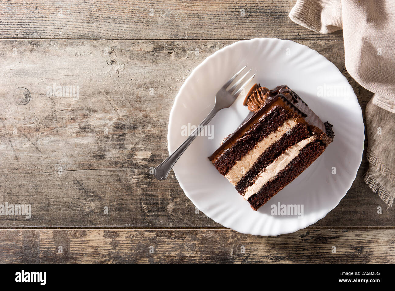 Chocolate cake slice on wooden table Stock Photo - Alamy