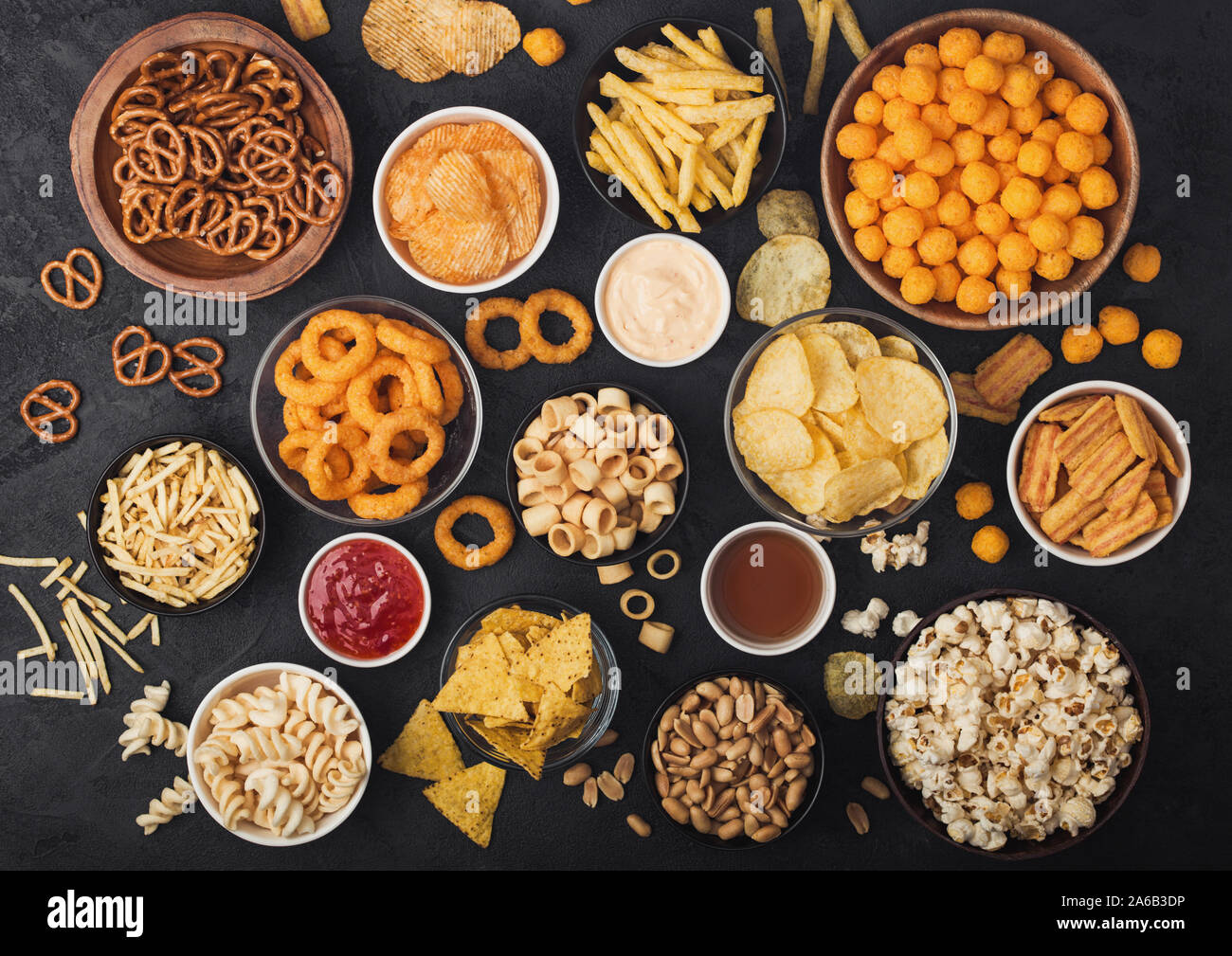 All classic potato snacks with peanuts, popcorn and onion rings and ...