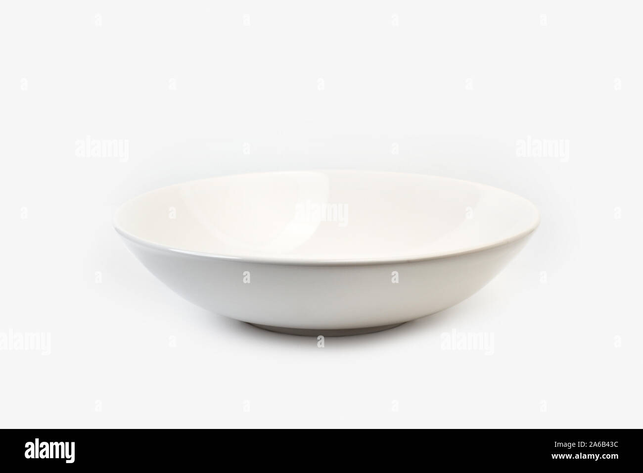 A deep white ceramic plate on a white background Stock Photo - Alamy