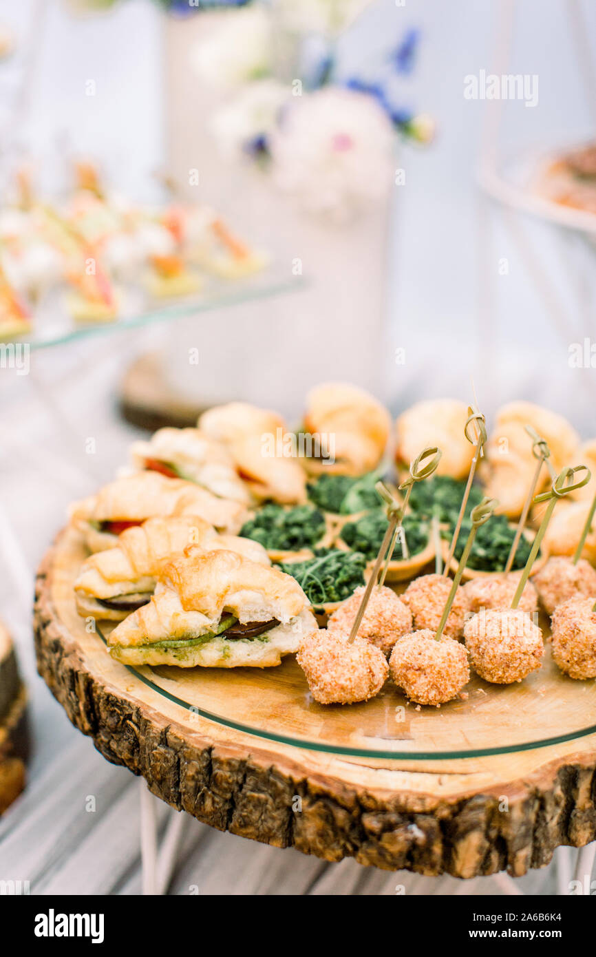Catering service. Restaurant table with food at event. Round wooden ...