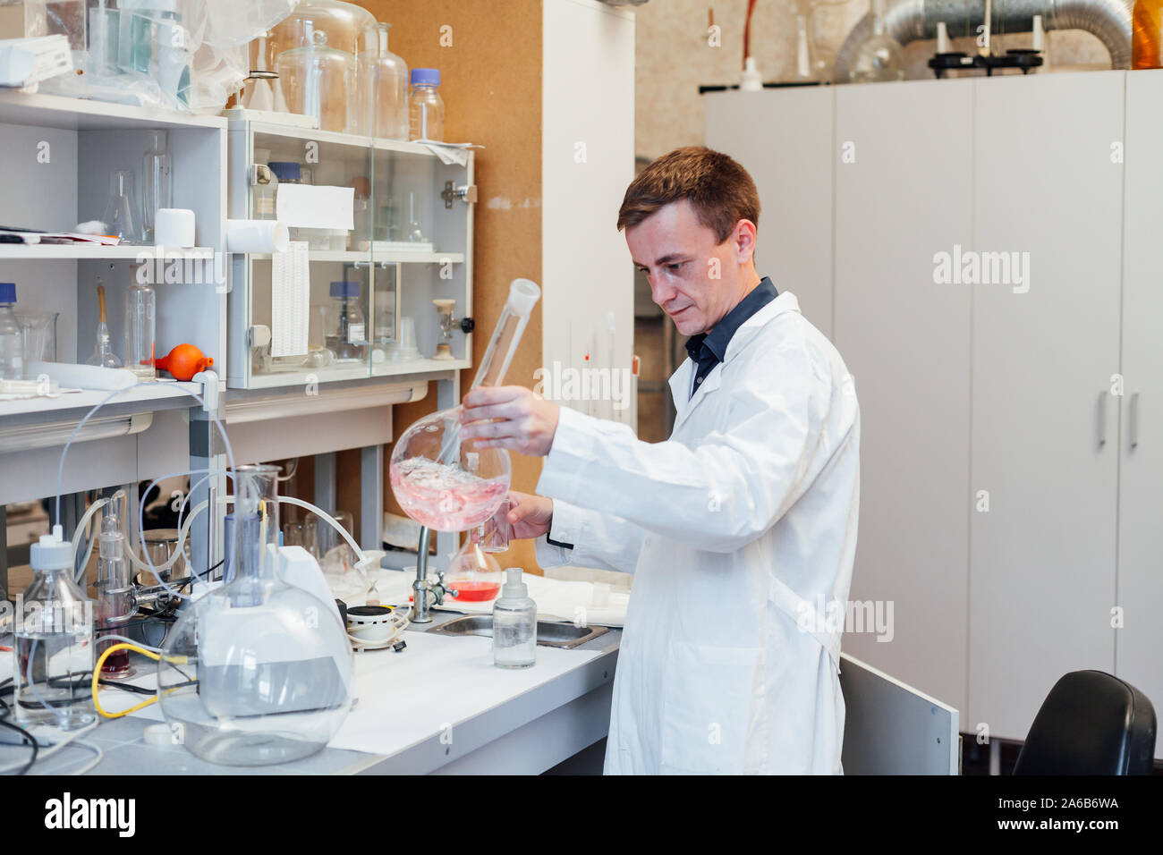 scientist in the medical laboratory conducts chemical experiments with ...