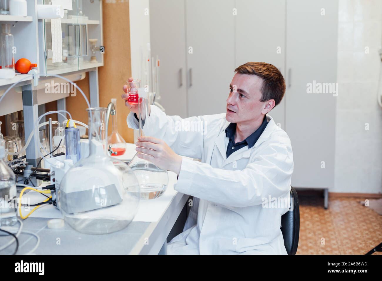 scientist in the medical laboratory conducts chemical experiments with ...