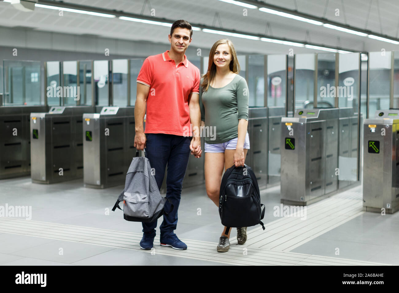 Man with his girlfriend are standing near turnstiles in the underground Stock Photo - Alamy