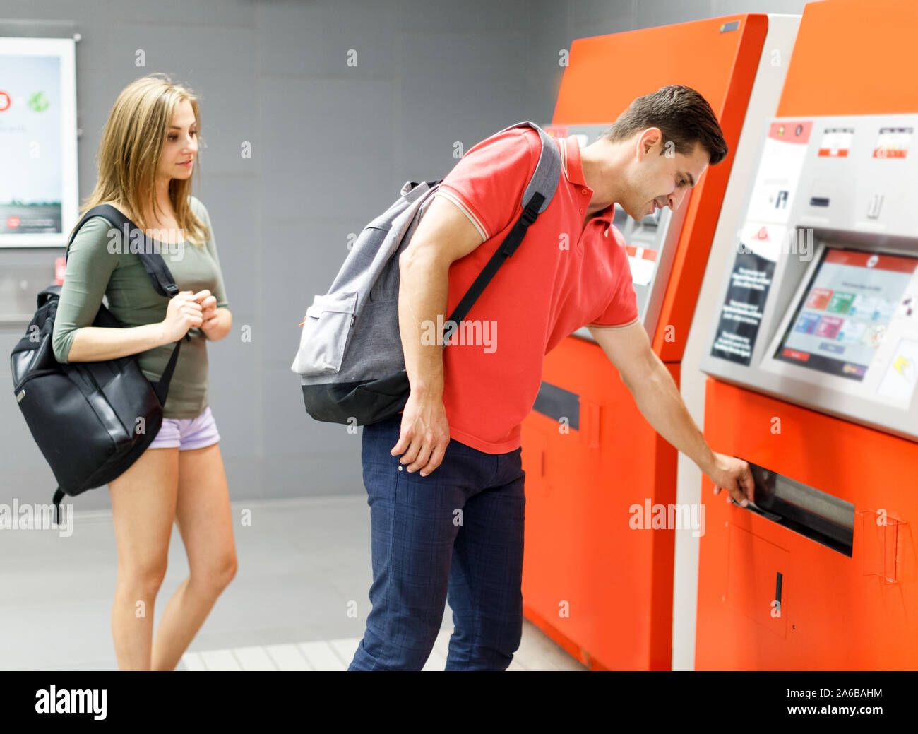 Couple is buying tickets and moving around the city using the metro ...
