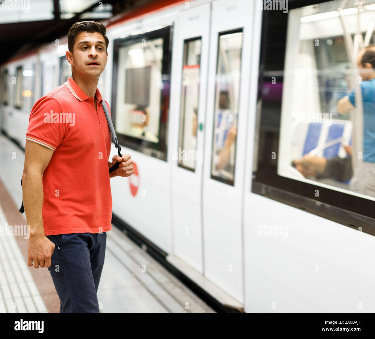 Man is standing on platform and running into train Stock Photo - Alamy