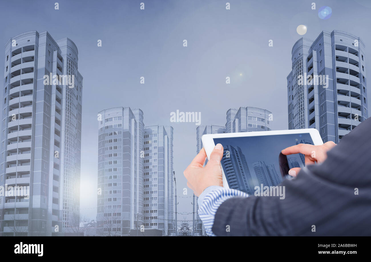 Woman touching digital tablet screen on background with skyscrapers ...