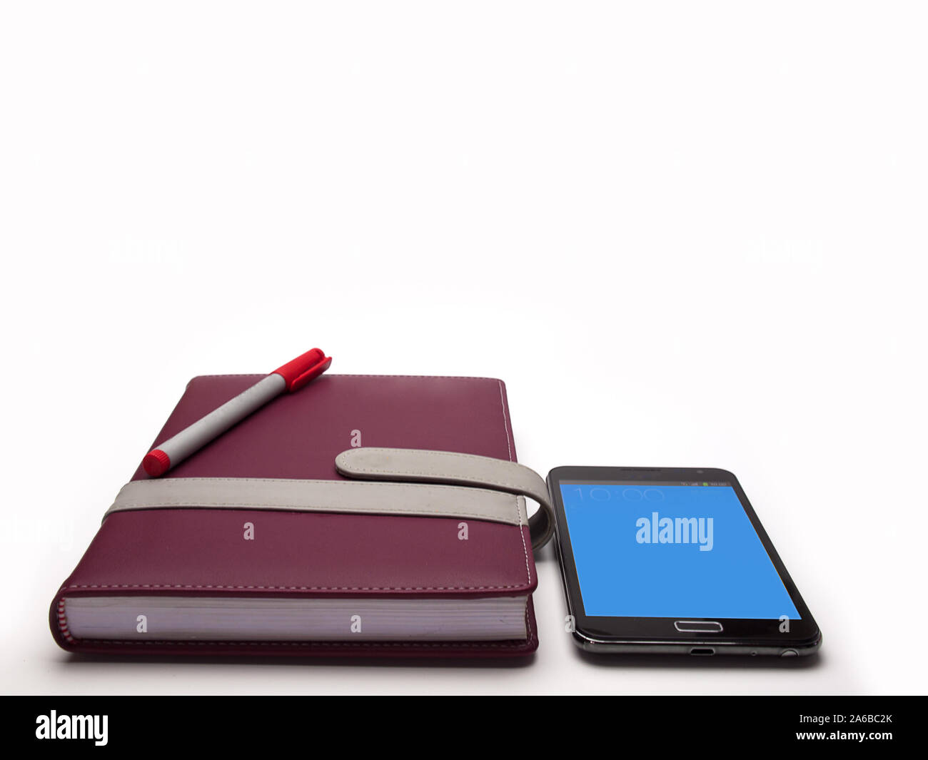 Mobile phone on book , on white background Stock Photo - Alamy
