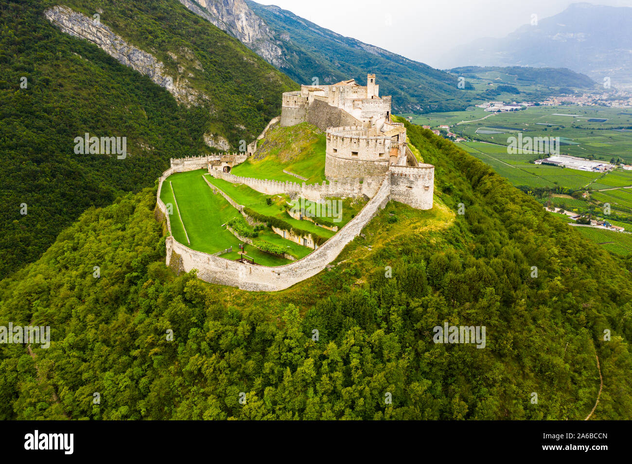Scenic aerial view of large fortified Beseno castle on top of hill in ...