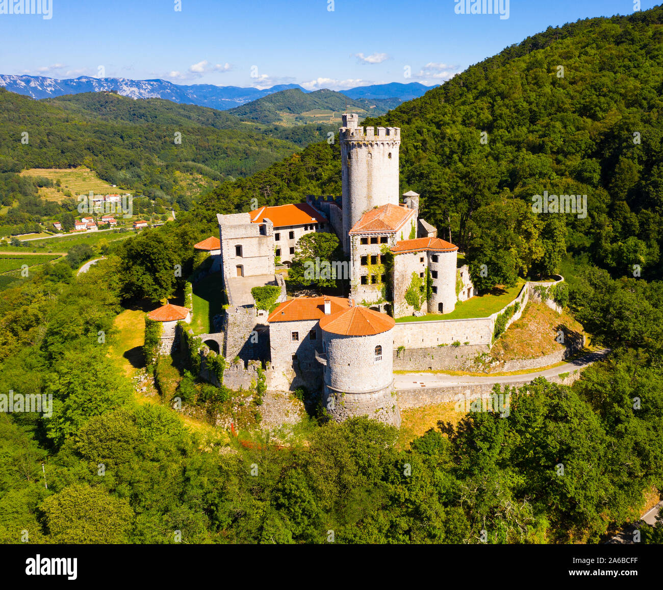 Aerial view of impressive medieval Branik Castle on hill above village ...