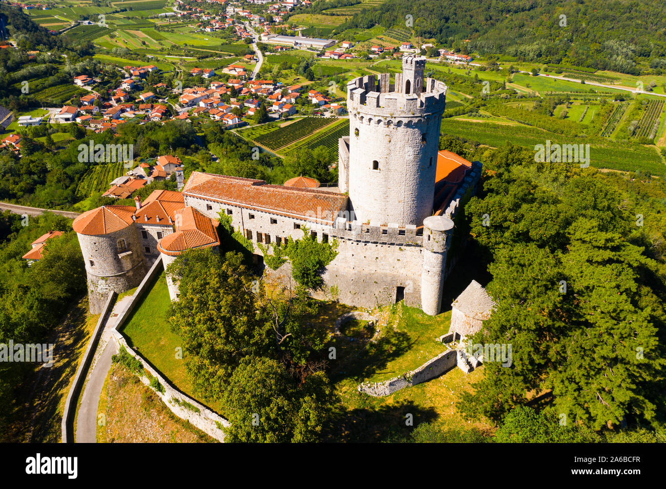 Aerial view of impressive medieval Branik Castle on hill above village ...