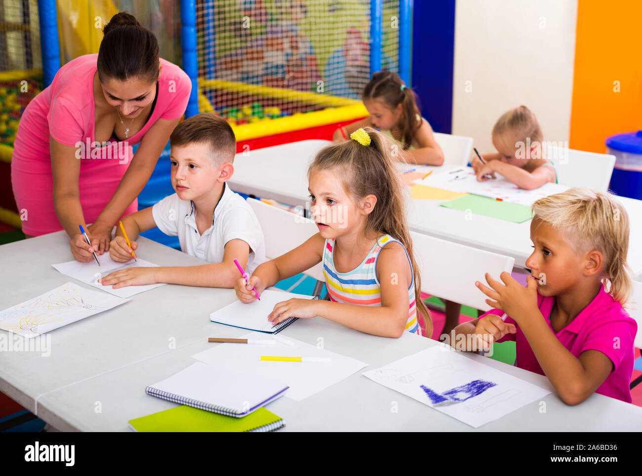 little spanish children sitting together and studying in class at ...