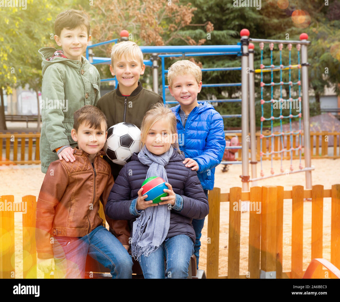 Portrait of happy kids standing together on playground in autumn day ...