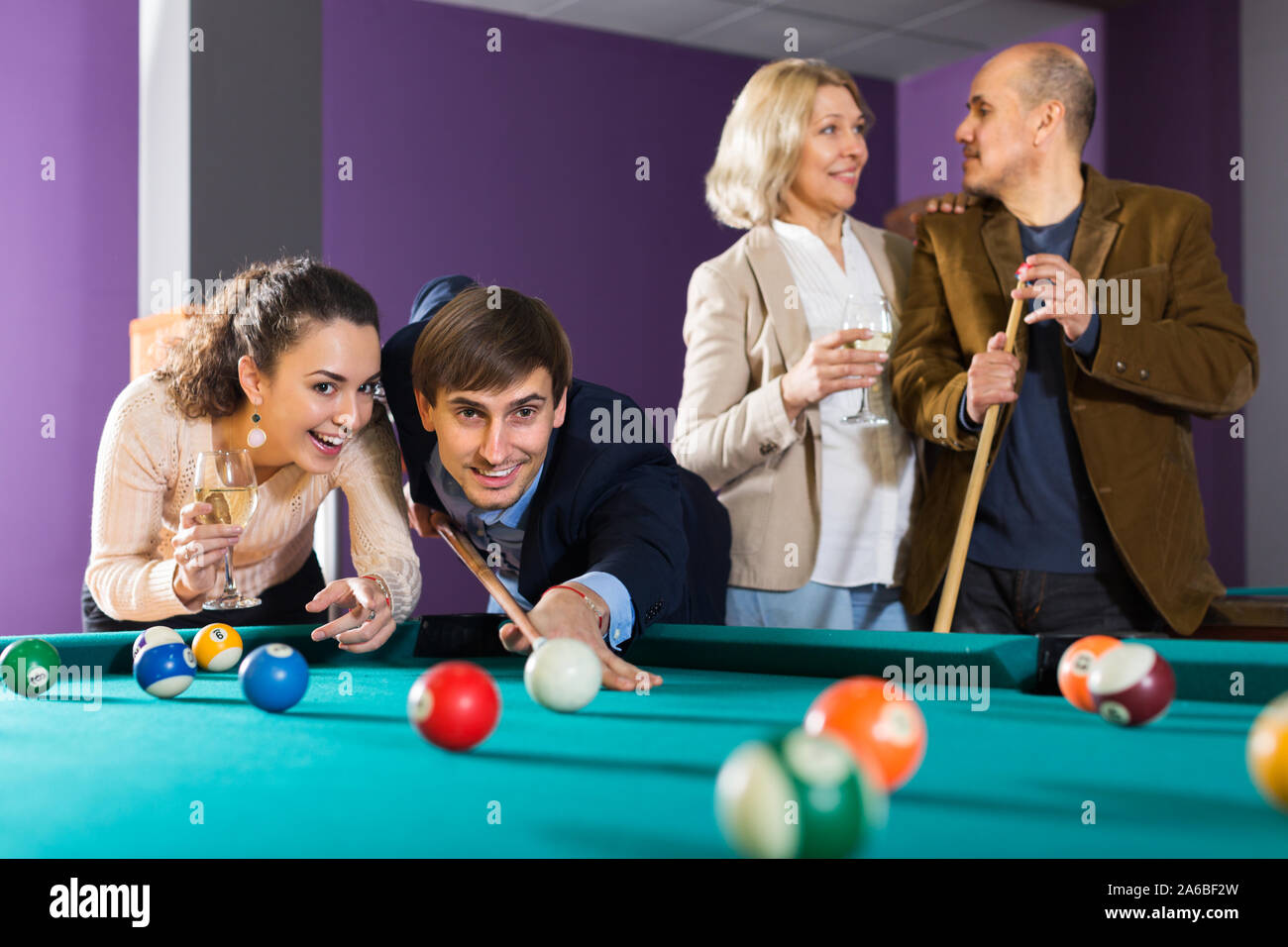 Smiling adult people playing billiard and darts as hanging out Stock ...