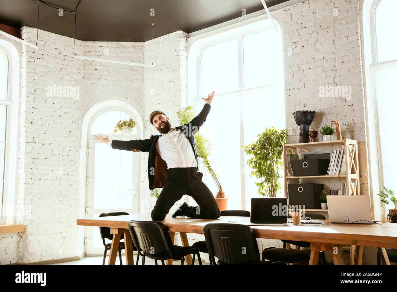 Young caucasian businessman having fun dancing break dance in the ...