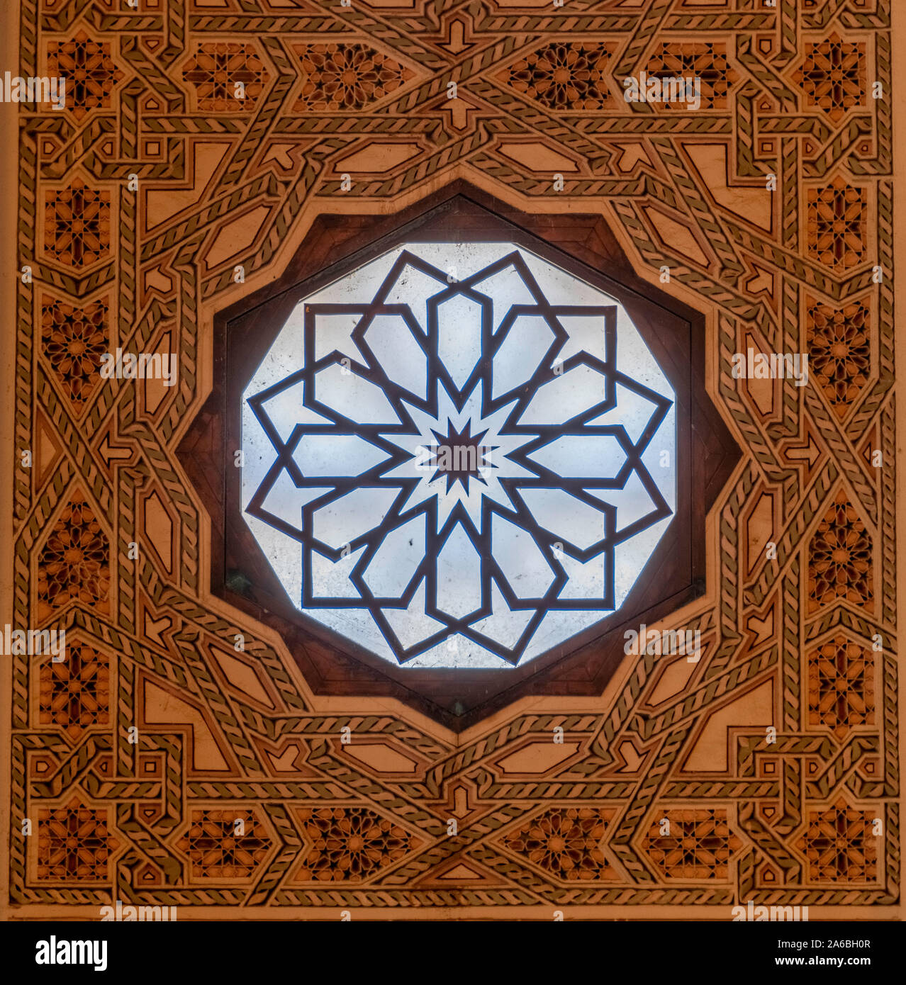 Ornate round window with patterned square frame taken in mosque Stock ...