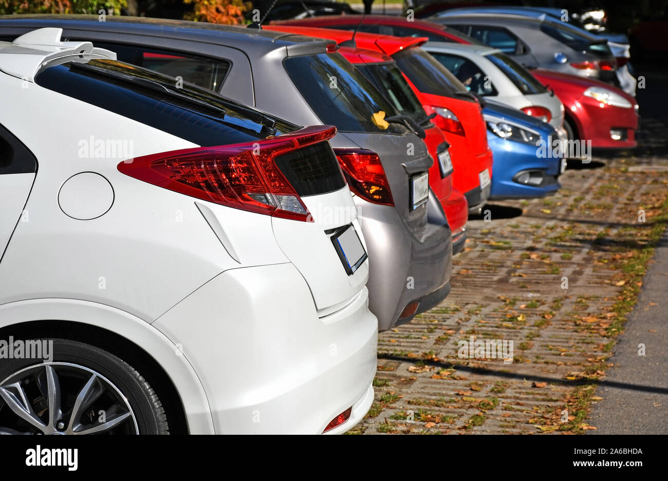Cars in the parking lot in a row Stock Photo - Alamy