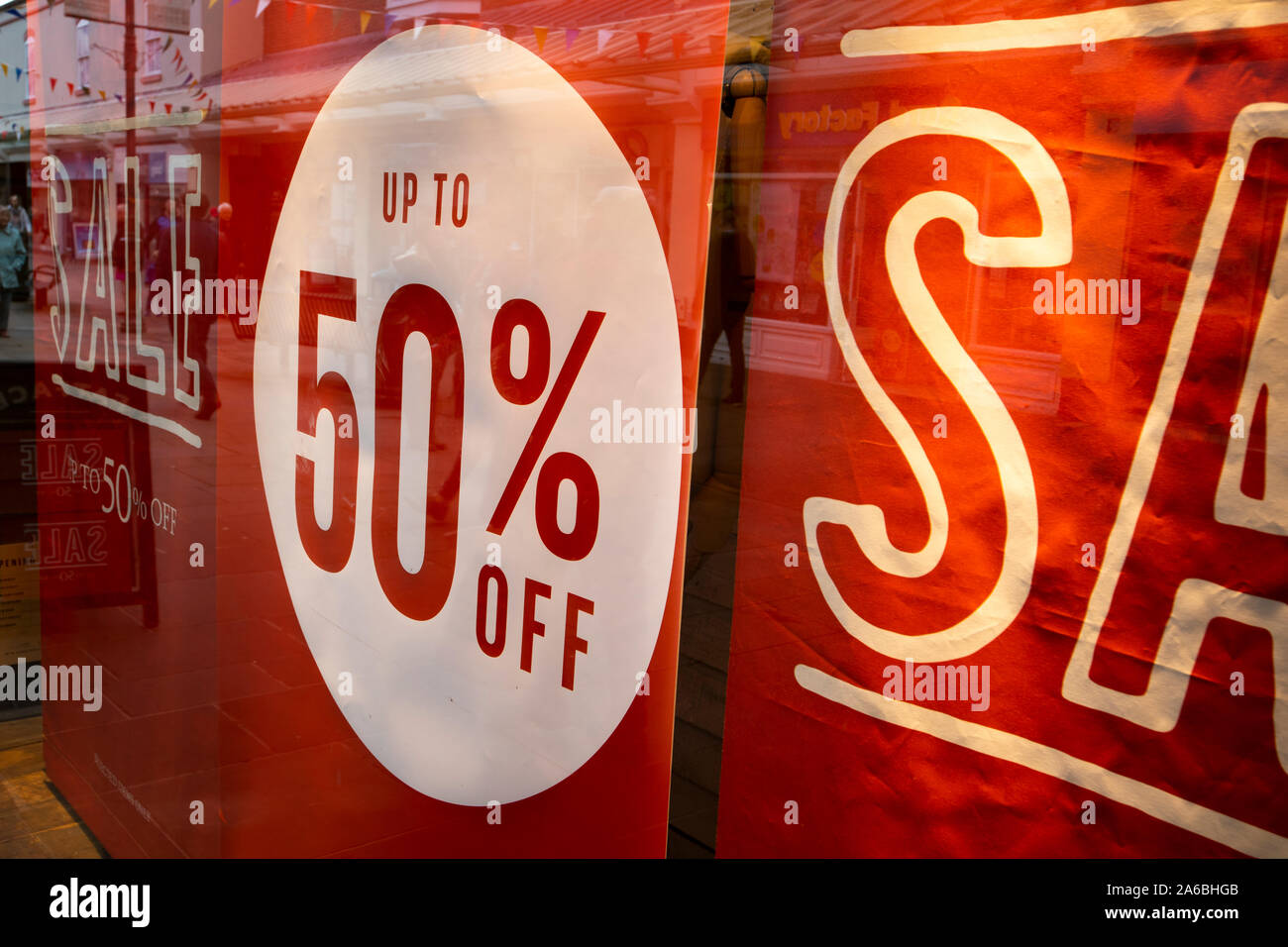 fifty percent off sale sign in womenswear shop window highlighting the ...