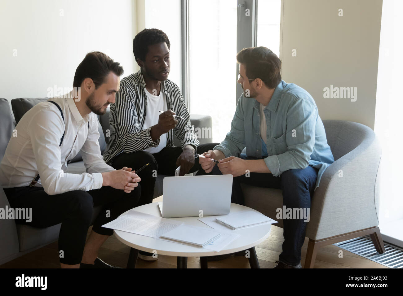 Diverse colleagues listening to African American man, working together ...