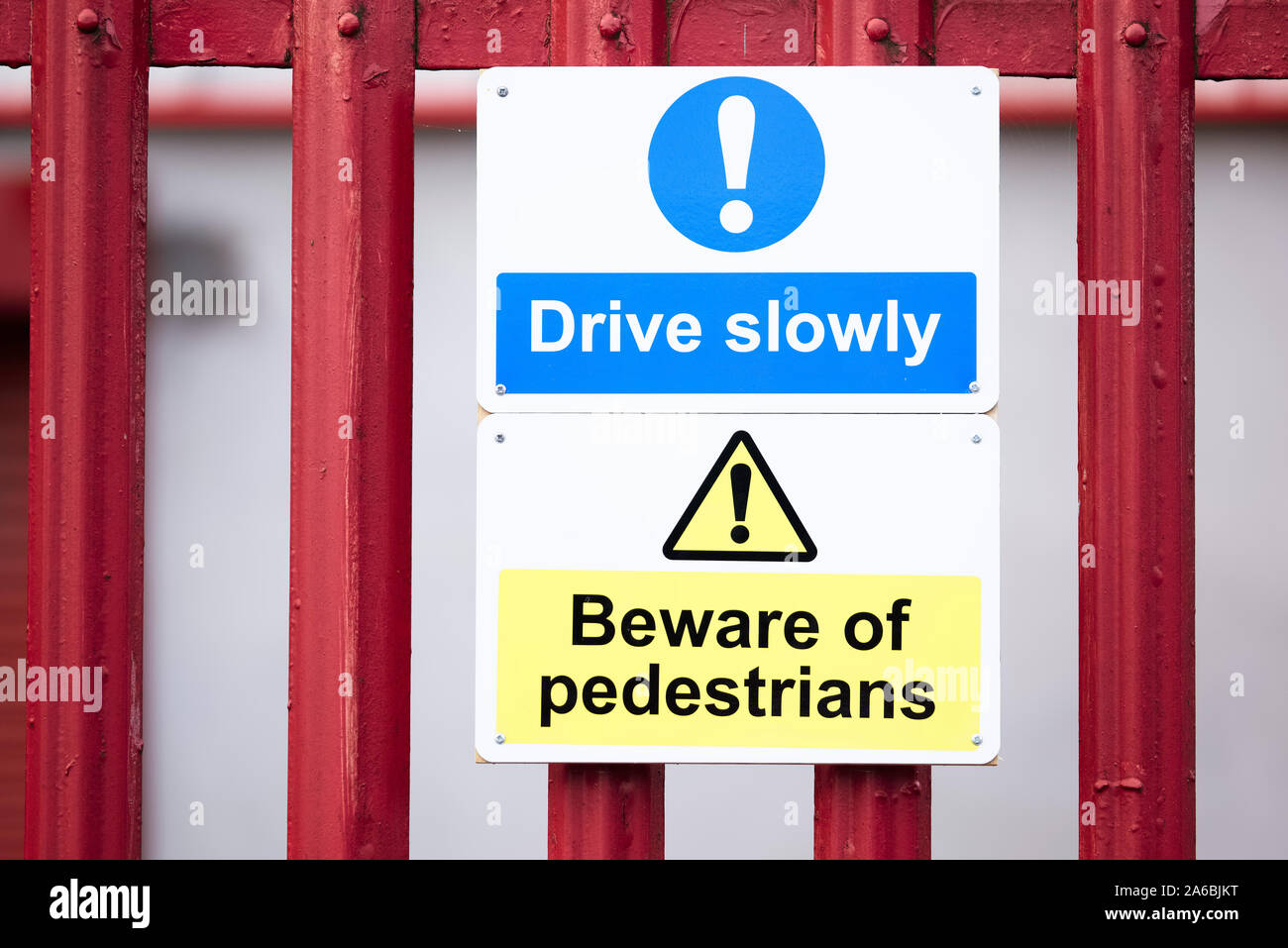 Beware of pedestrians drive slowly sign Stock Photo - Alamy